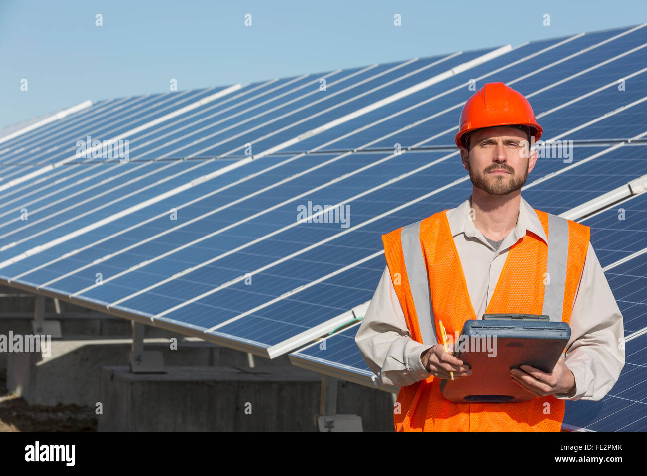 Power engineer at solar photovoltaic array taking notes Stock Photo - Alamy