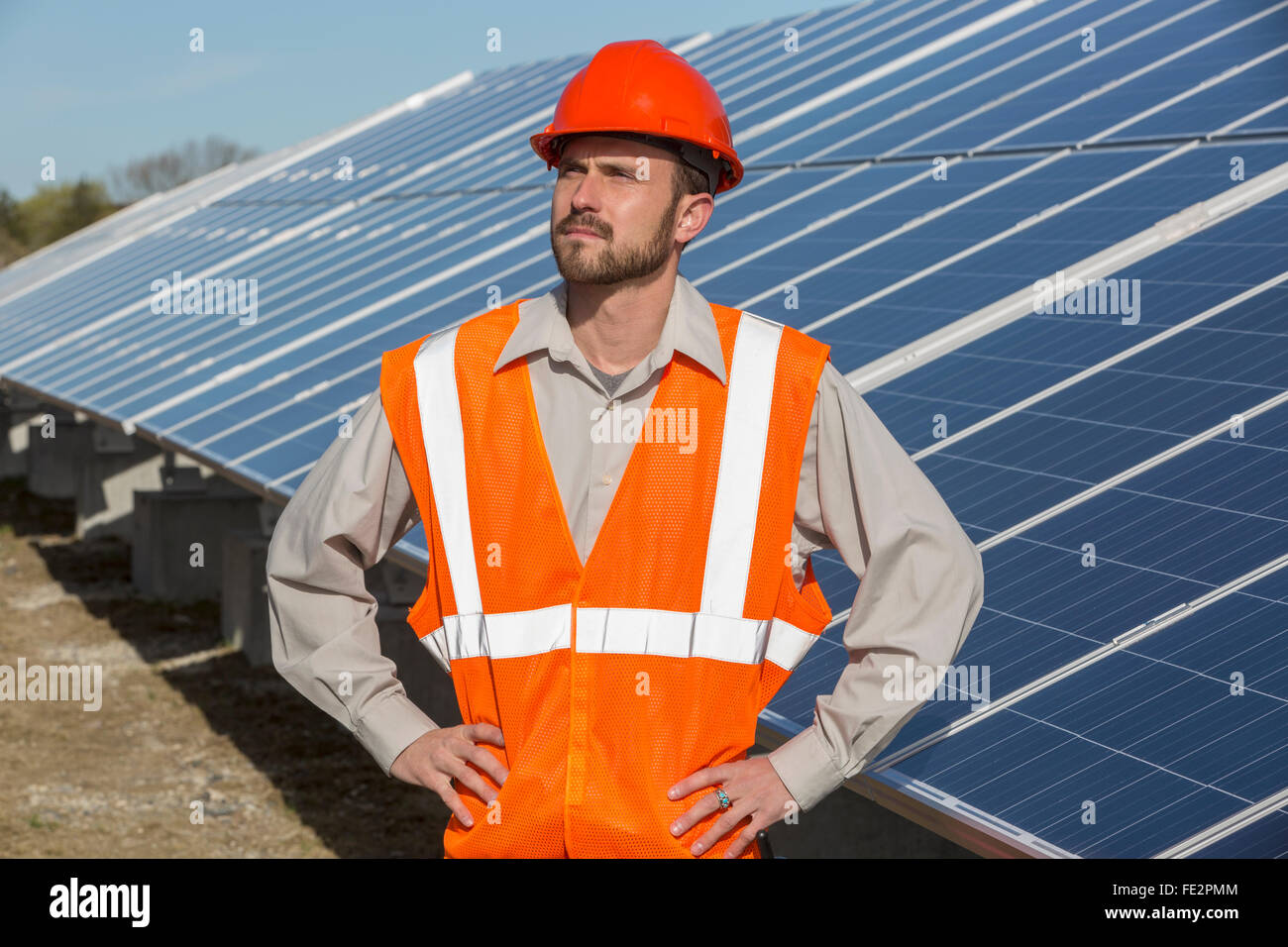 Power engineer standing at solar photovoltaic array Stock Photo - Alamy