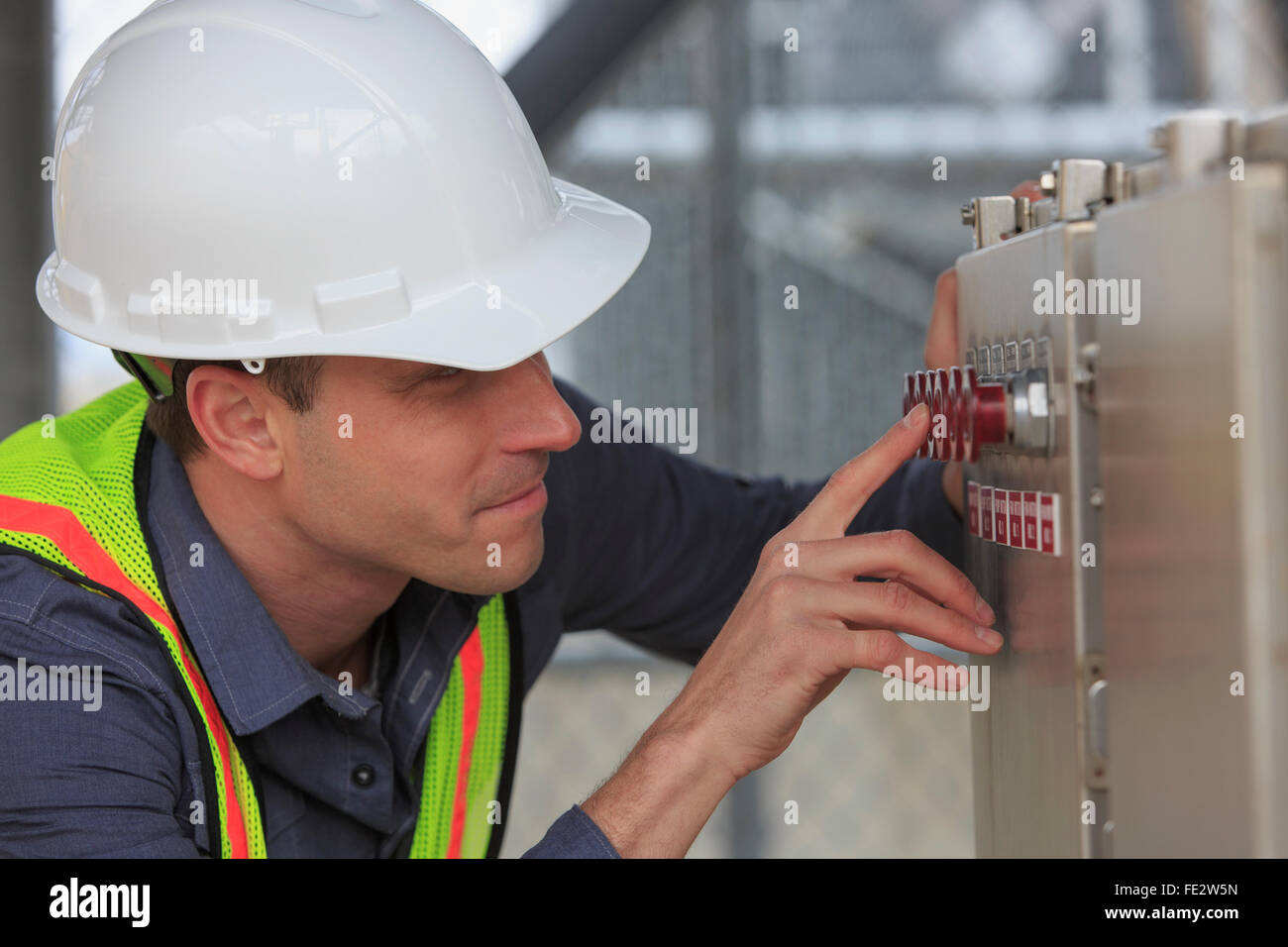 Industrial engineer checking safety buttons at a power plant Stock ...