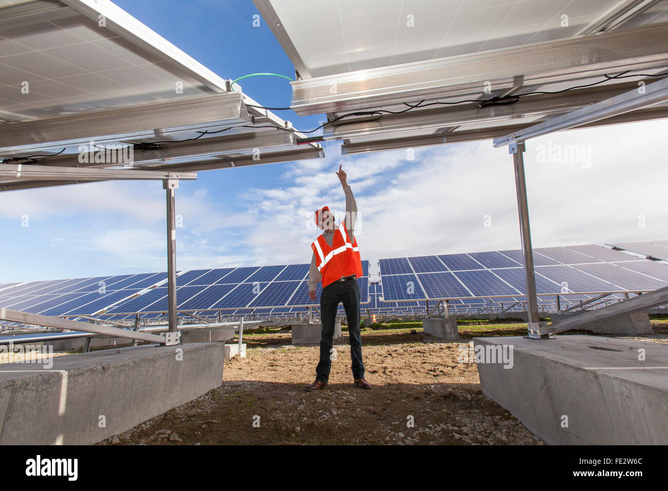 Solar photovoltaic installer examining racking for a PV array Stock ...