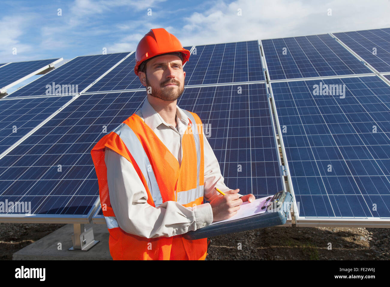 Power engineer taking notes at solar photovoltaic array Stock Photo - Alamy