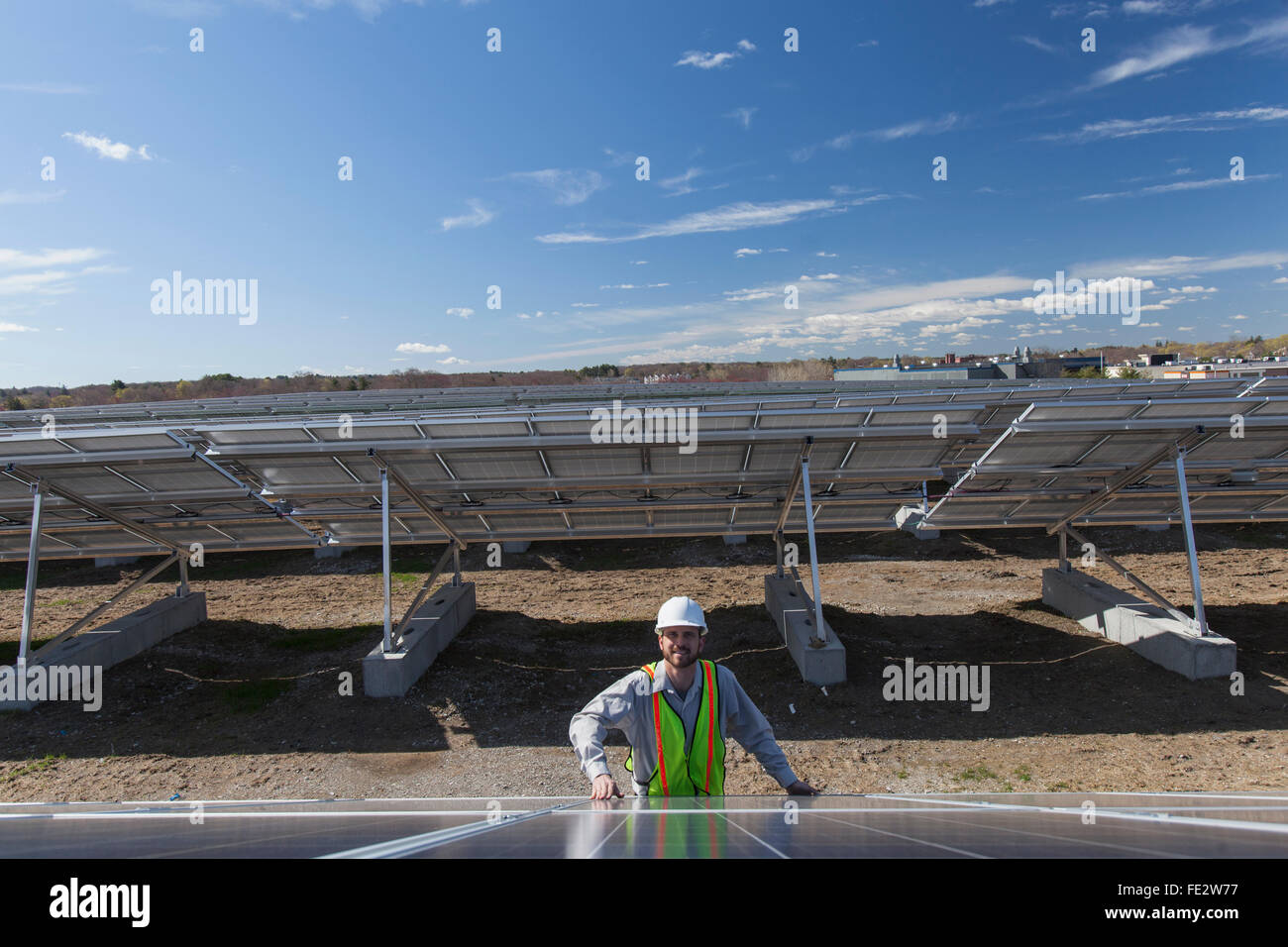 Power engineer examining surface of solar photovoltaic array Stock ...