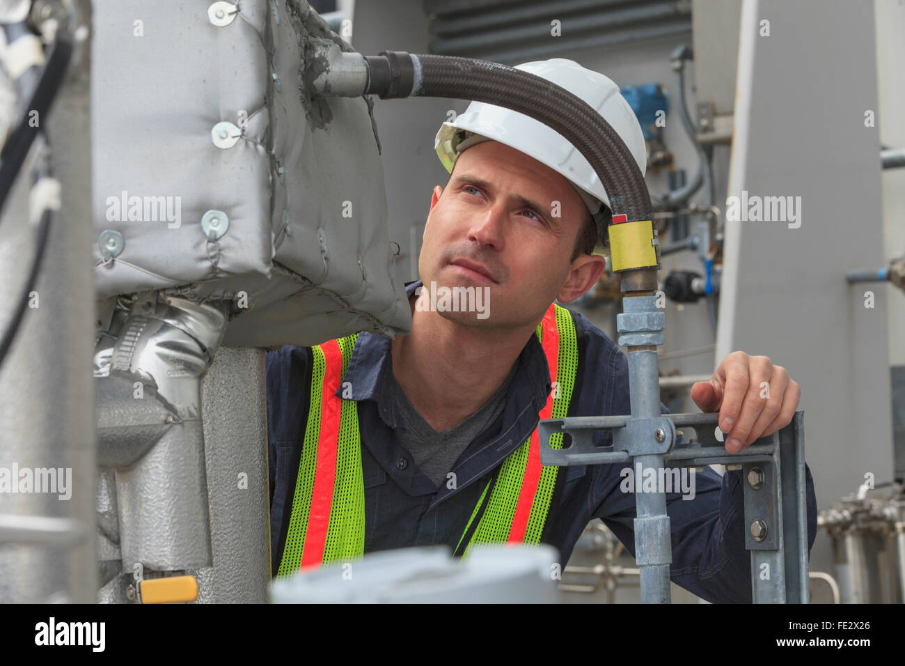 Industrial engineer examining high temperature sensor connections at a ...