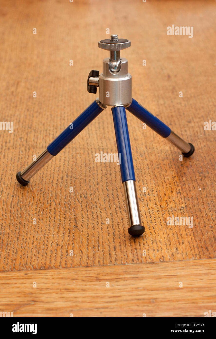 Small table top camera tripod with telescopic legs Stock Photo - Alamy