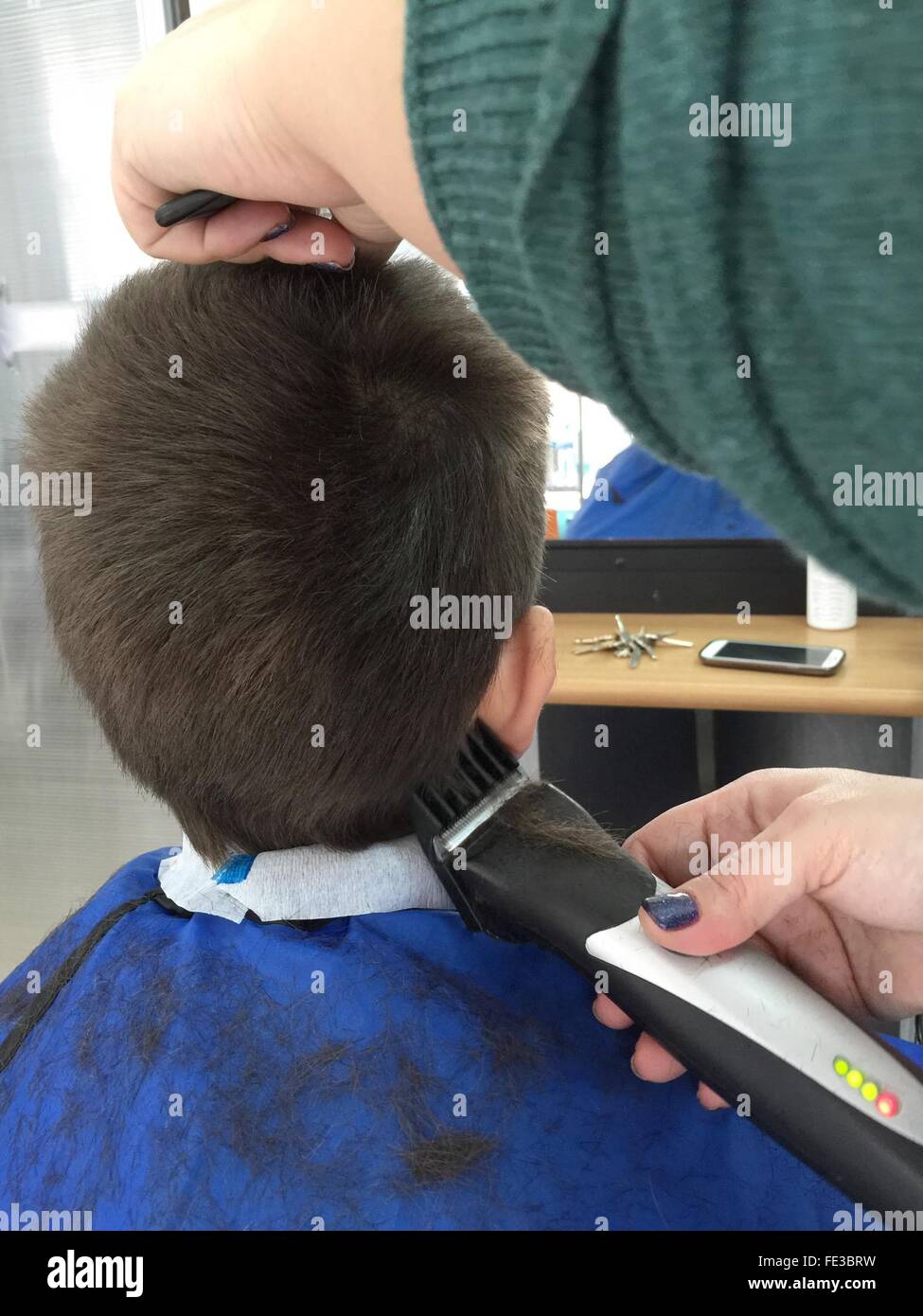Barber cutting boy's hair hi-res stock photography and images - Alamy