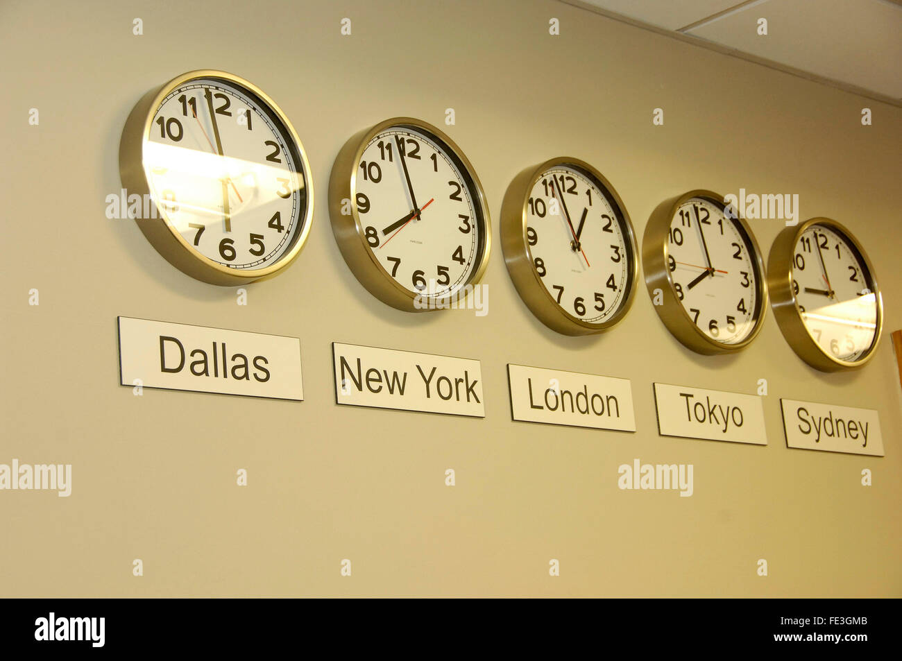 Clocks in a city office Stock Photo - Alamy