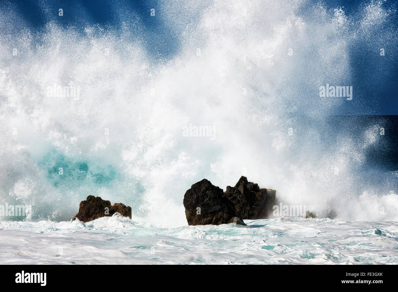 Massive waves explode against the offshore lava rocks at Laupahoehoe ...