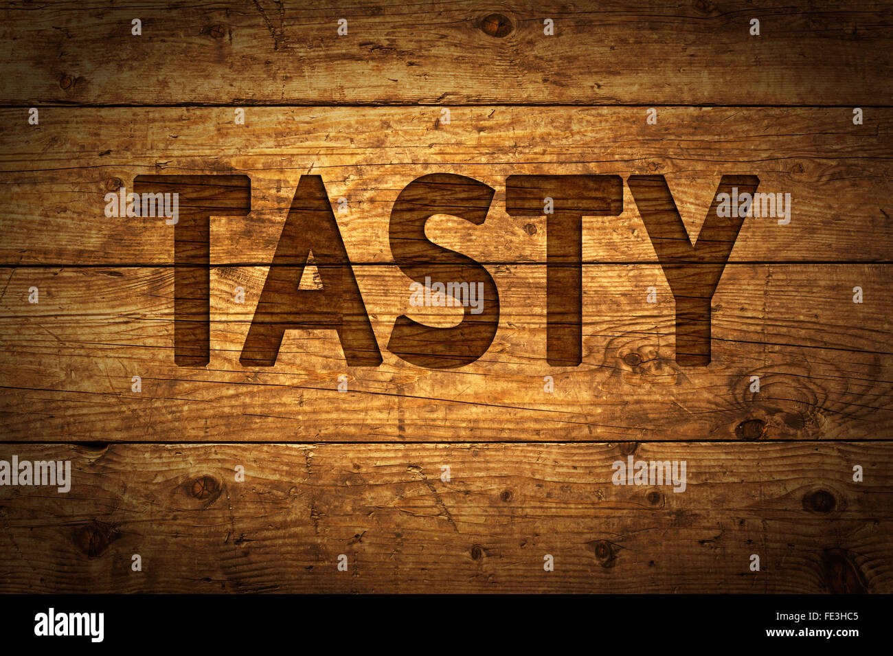 Grunge wood with text Tasty Stock Photo - Alamy