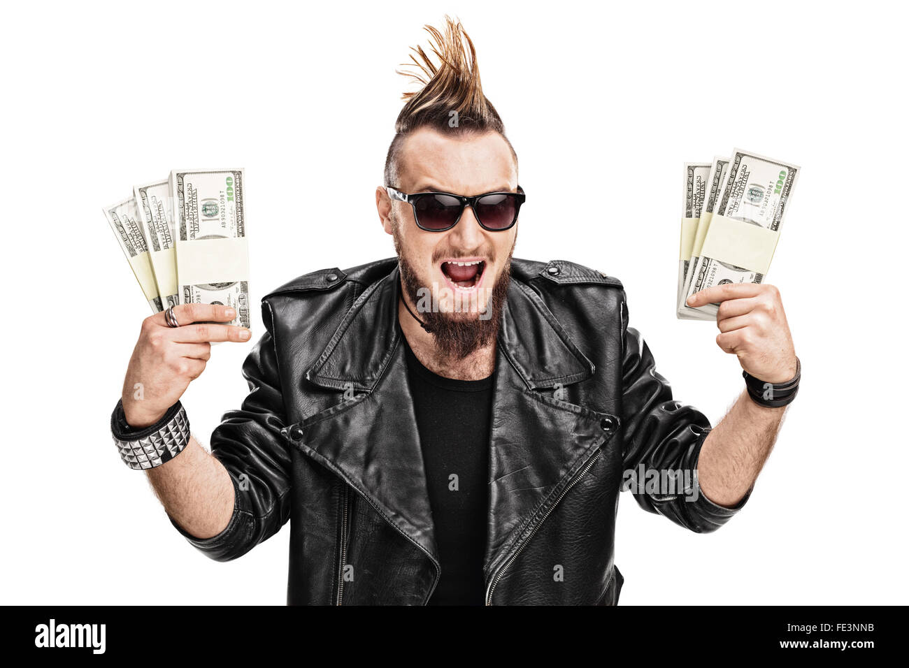 Male punk rocker holding a few stacks of money and looking at the ...