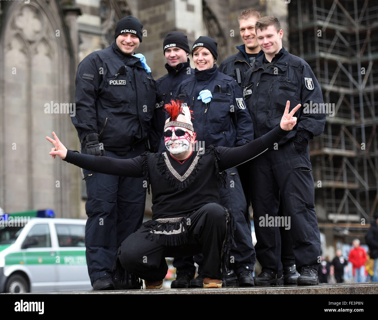 Cologne, Germany. 04th Feb, 2016. Police pose with a carnival reveller ...