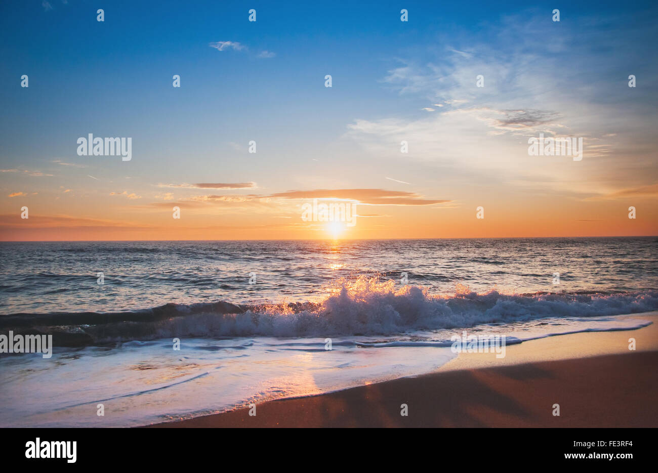 Sunrise on the beach Stock Photo - Alamy