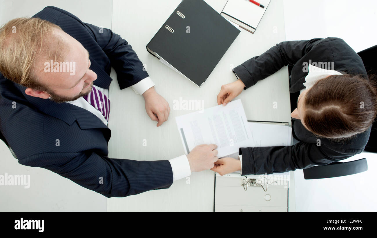 beard business man brunette woman at desk working above Stock Photo - Alamy