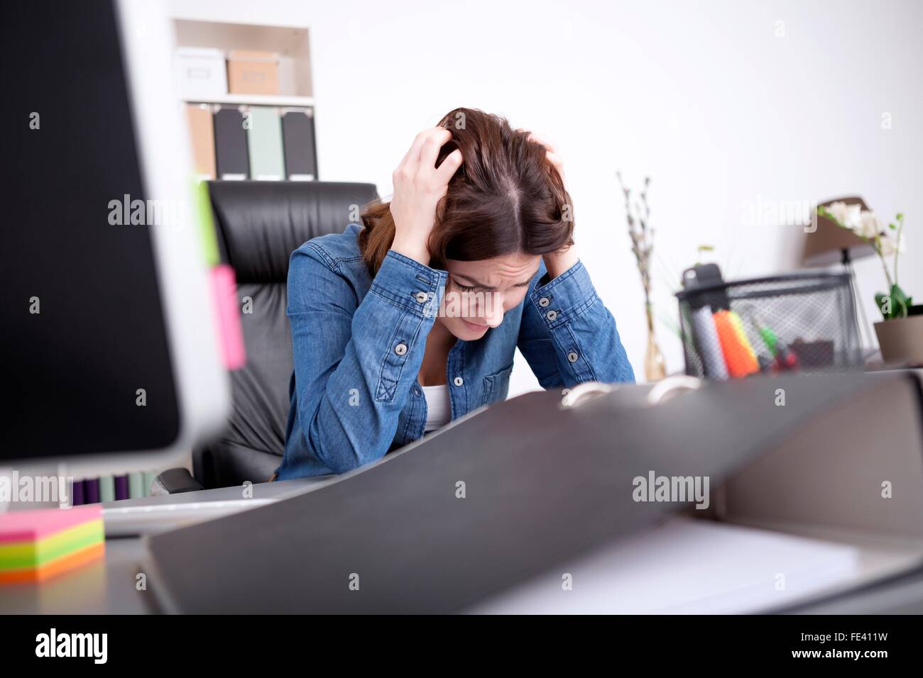 Hardworking dedicated businesswoman sitting at her desk in the office ...