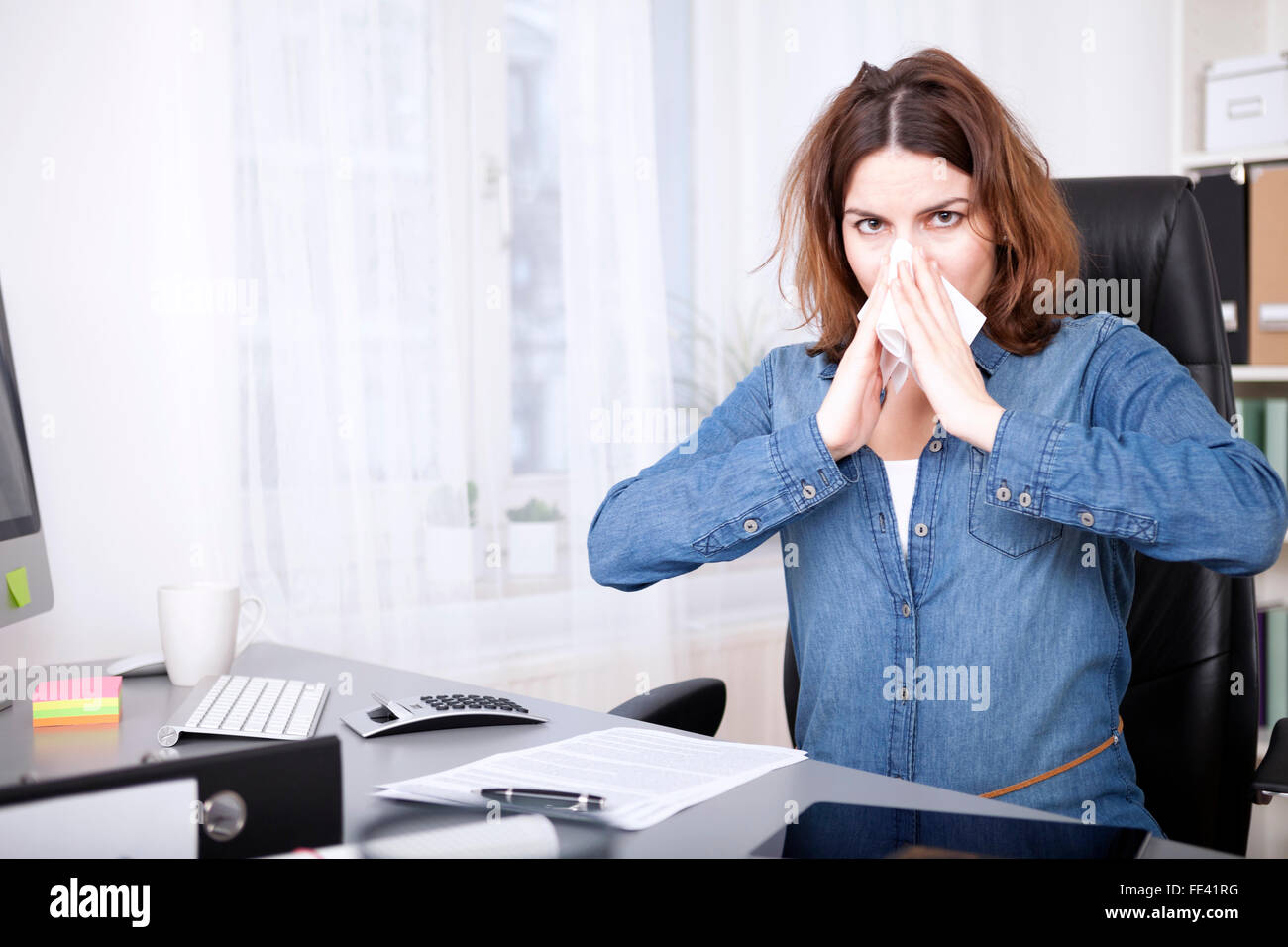 Woman sitting at desk cold hi-res stock photography and images - Alamy