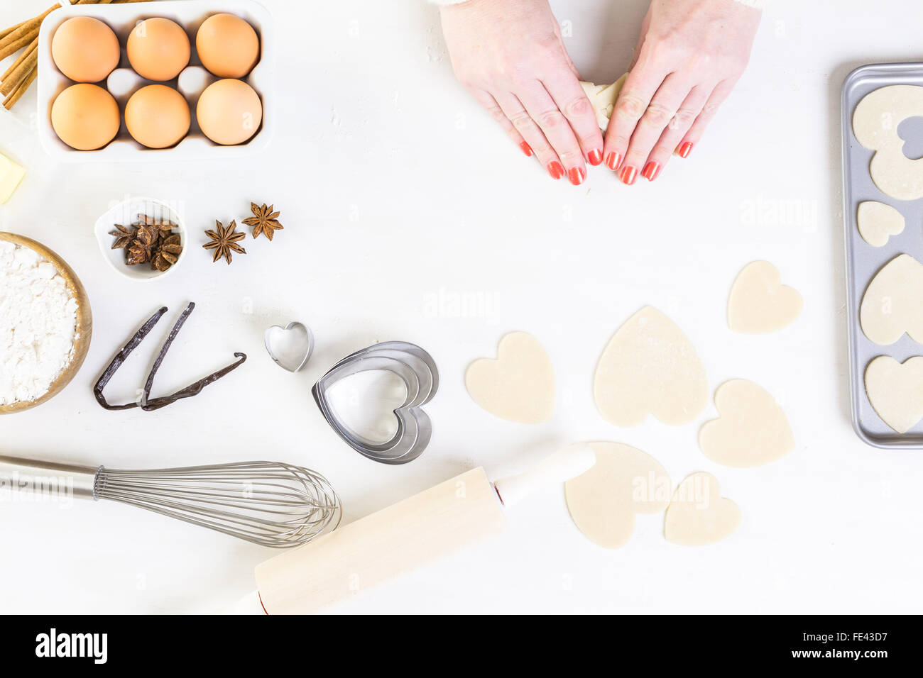 Baking heart shaped sugar cookies for Valentines Day Stock Photo - Alamy