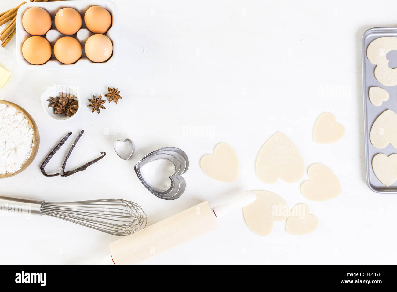 Baking heart shaped sugar cookies for Valentines Day Stock Photo - Alamy