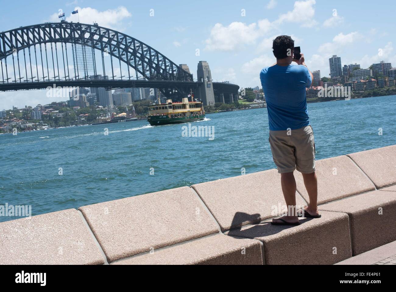 Rear View Of Man Taking Picture Of City Buildings Stock Photo - Alamy