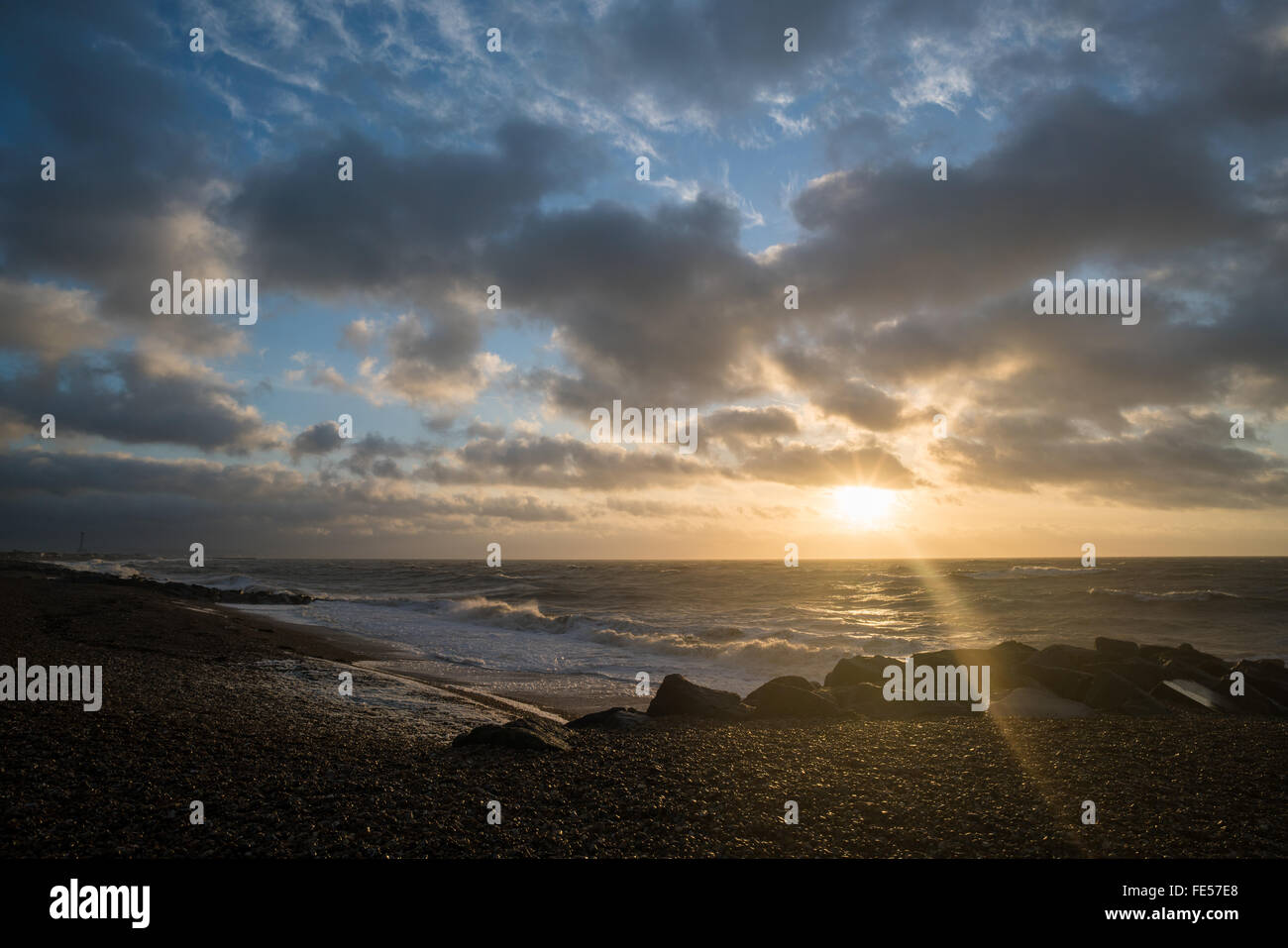 Looking across the Brighton pebbles at sunrise Stock Photo - Alamy