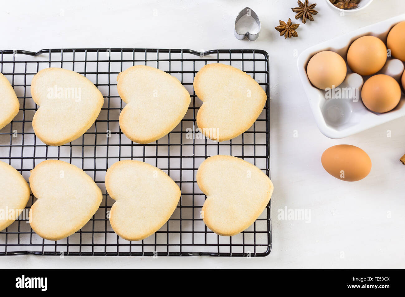 Baking heart shaped sugar cookies for Valentines Day Stock Photo - Alamy
