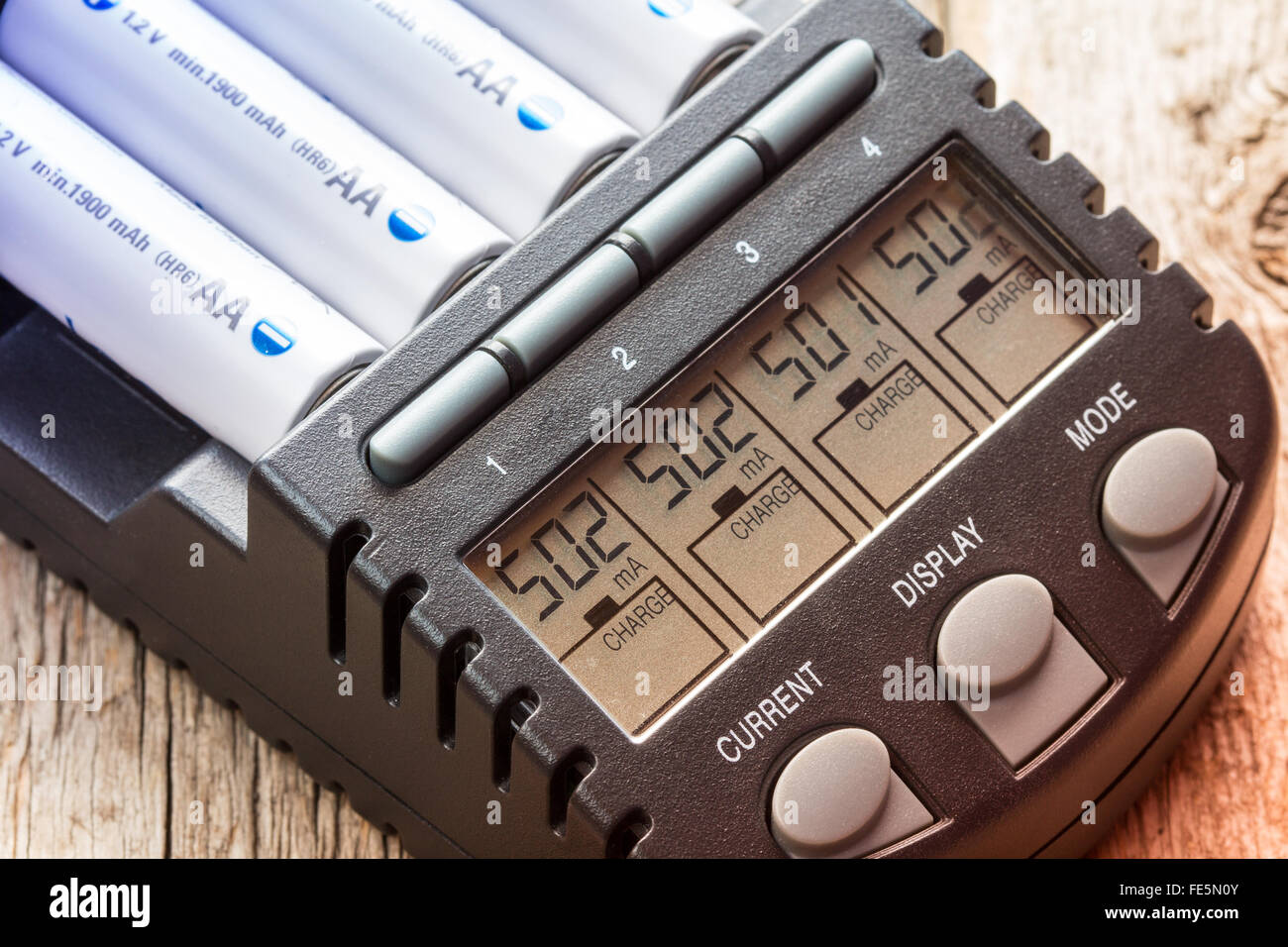 Battery charger with rechargeable batteries AA background Stock Photo ...