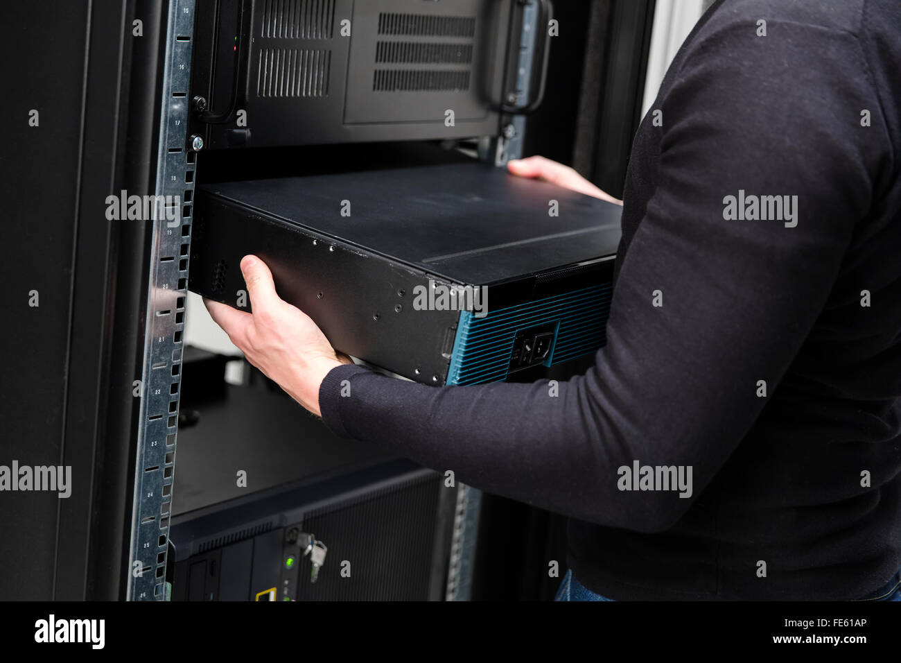 It consultant install network router in datacenter Stock Photo - Alamy