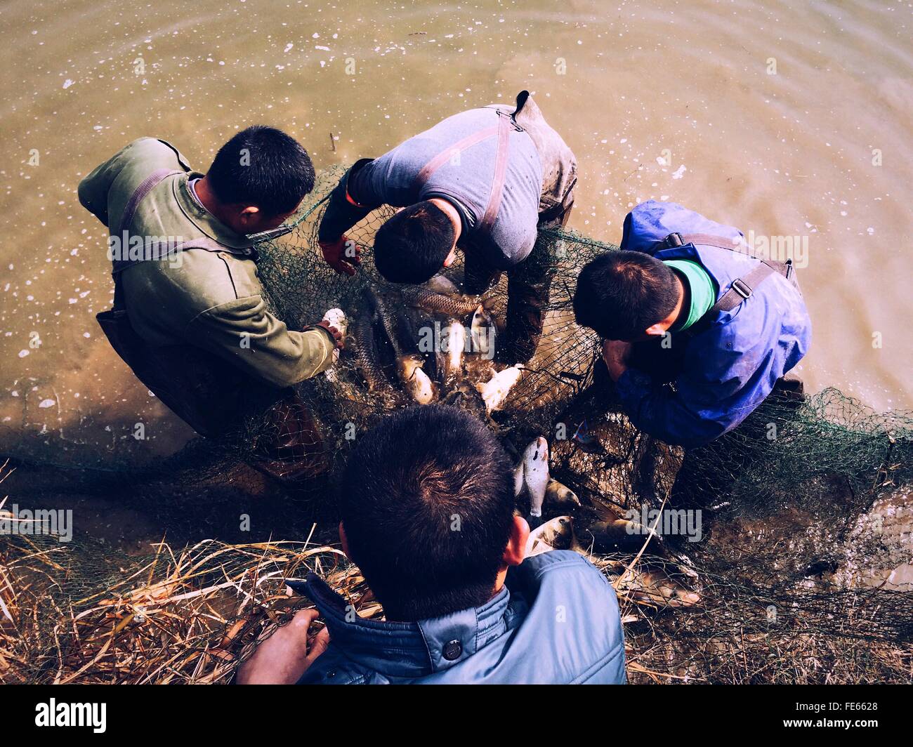 Men fishing with net hi-res stock photography and images - Alamy