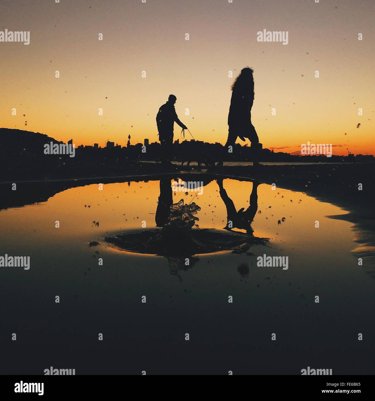 Two people walking at sunset hi-res stock photography and images - Alamy