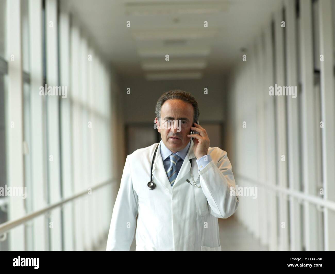 Portrait Of Doctor Using Mobile Phone In Hospital Stock Photo - Alamy
