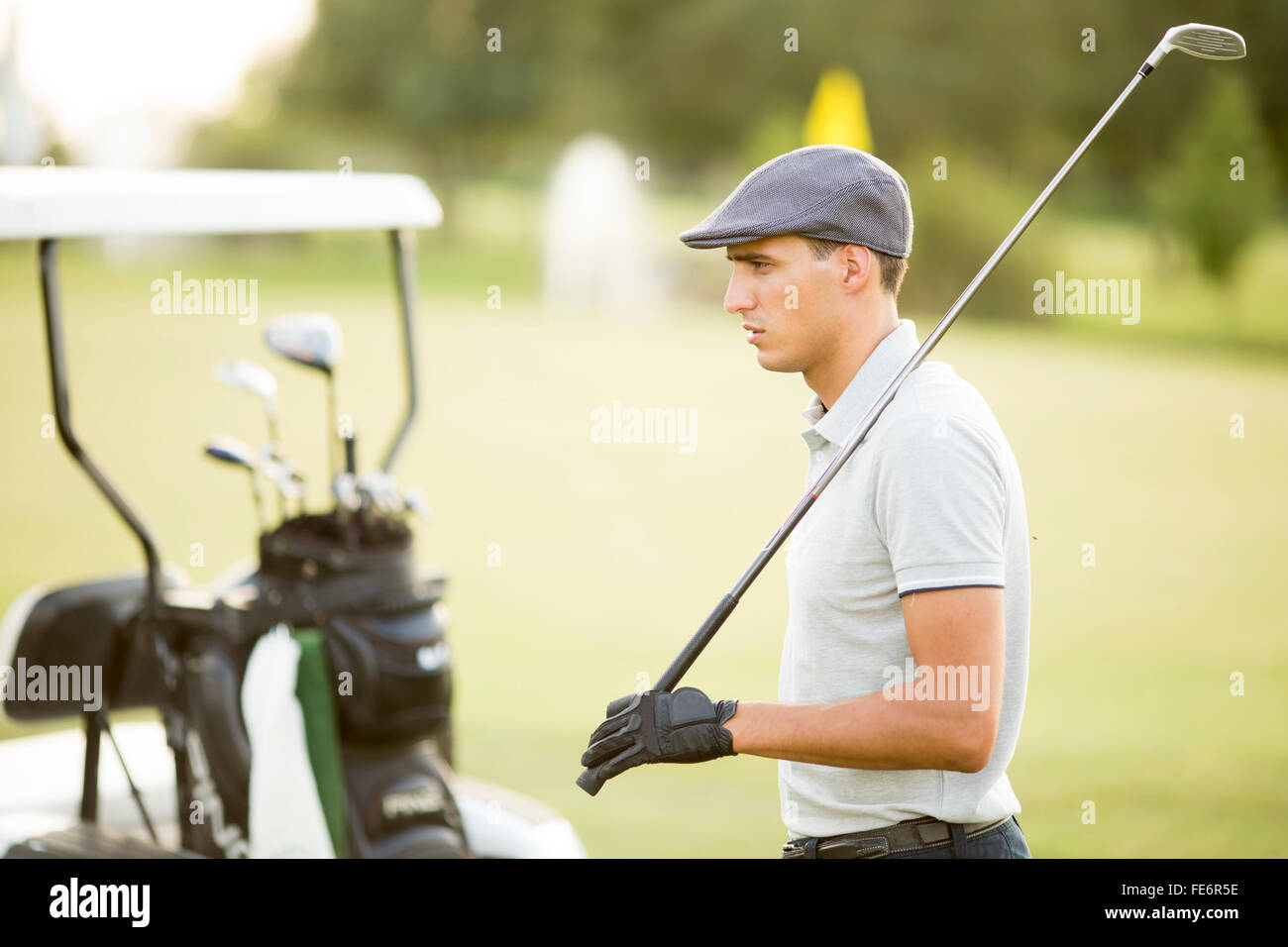 Young man playing golf Stock Photo - Alamy