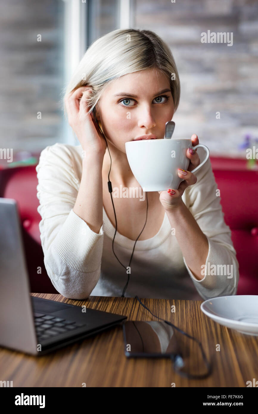 Woman working with laptop computer in cafe Stock Photo - Alamy