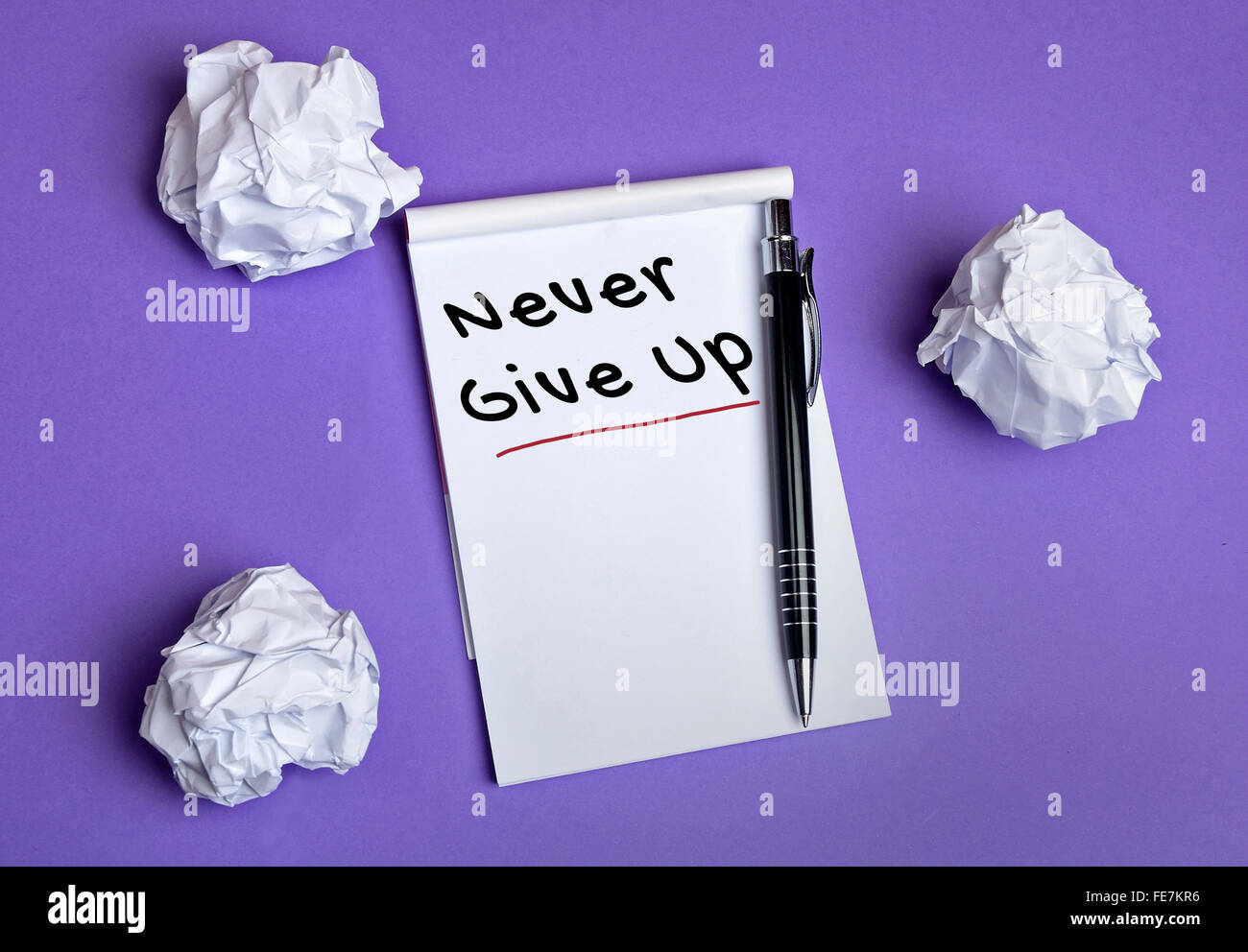 Never give up word on notebook Stock Photo - Alamy