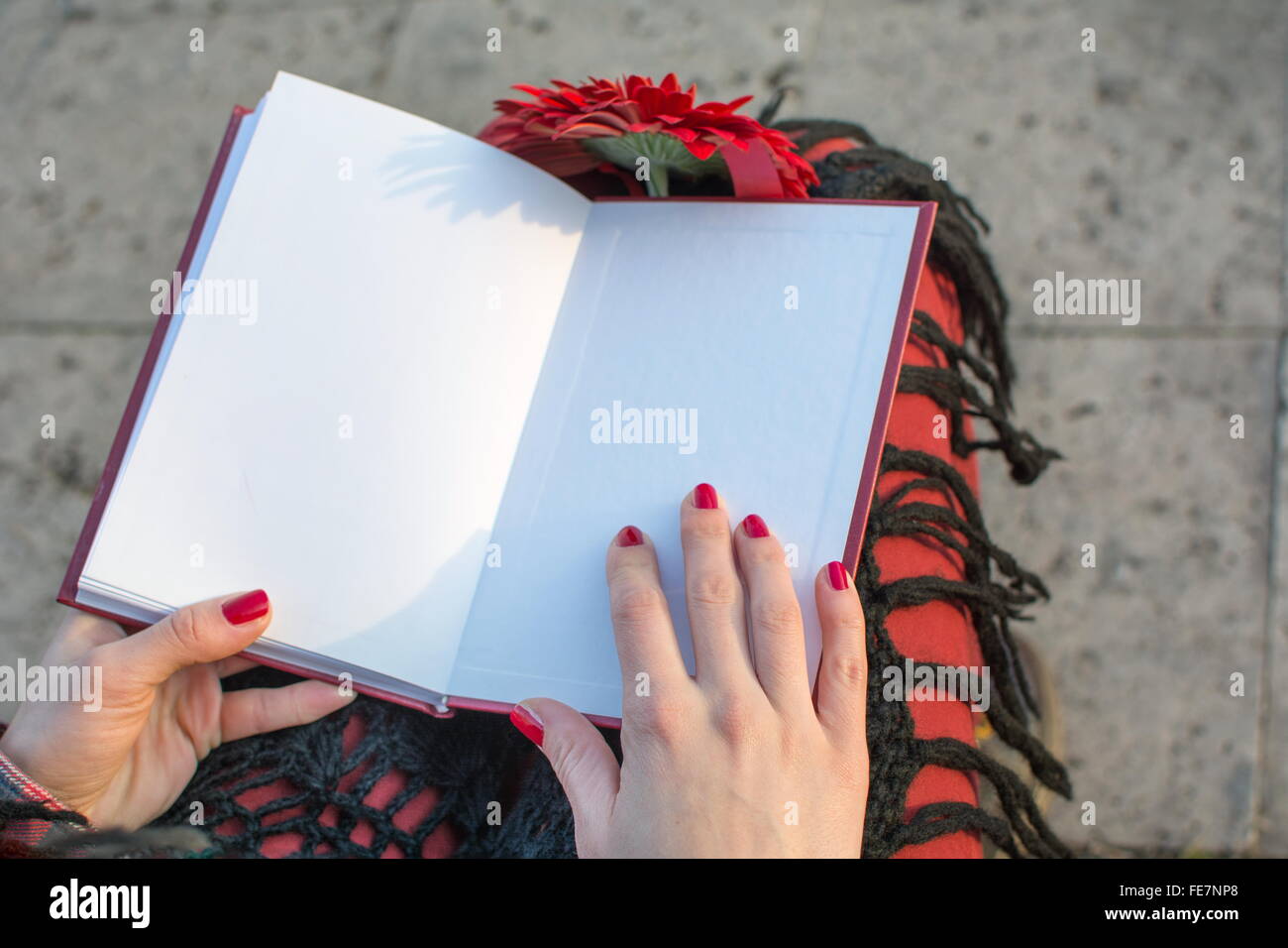 Brunette girl finished reading a book outdoors Stock Photo - Alamy