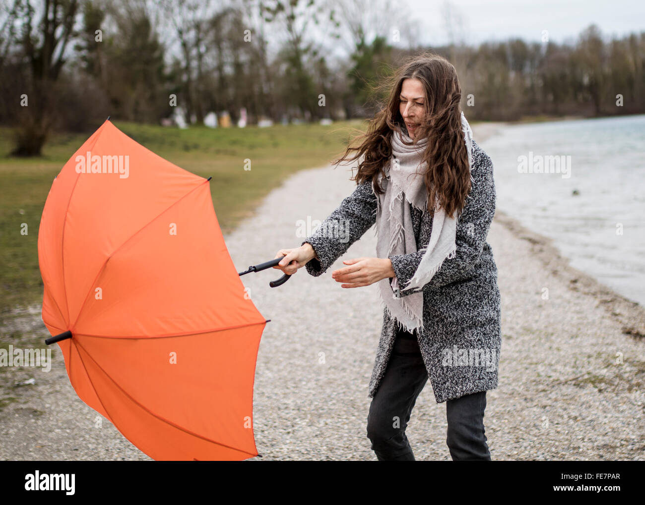 Woman umbrella rain storm hi-res stock photography and images - Alamy