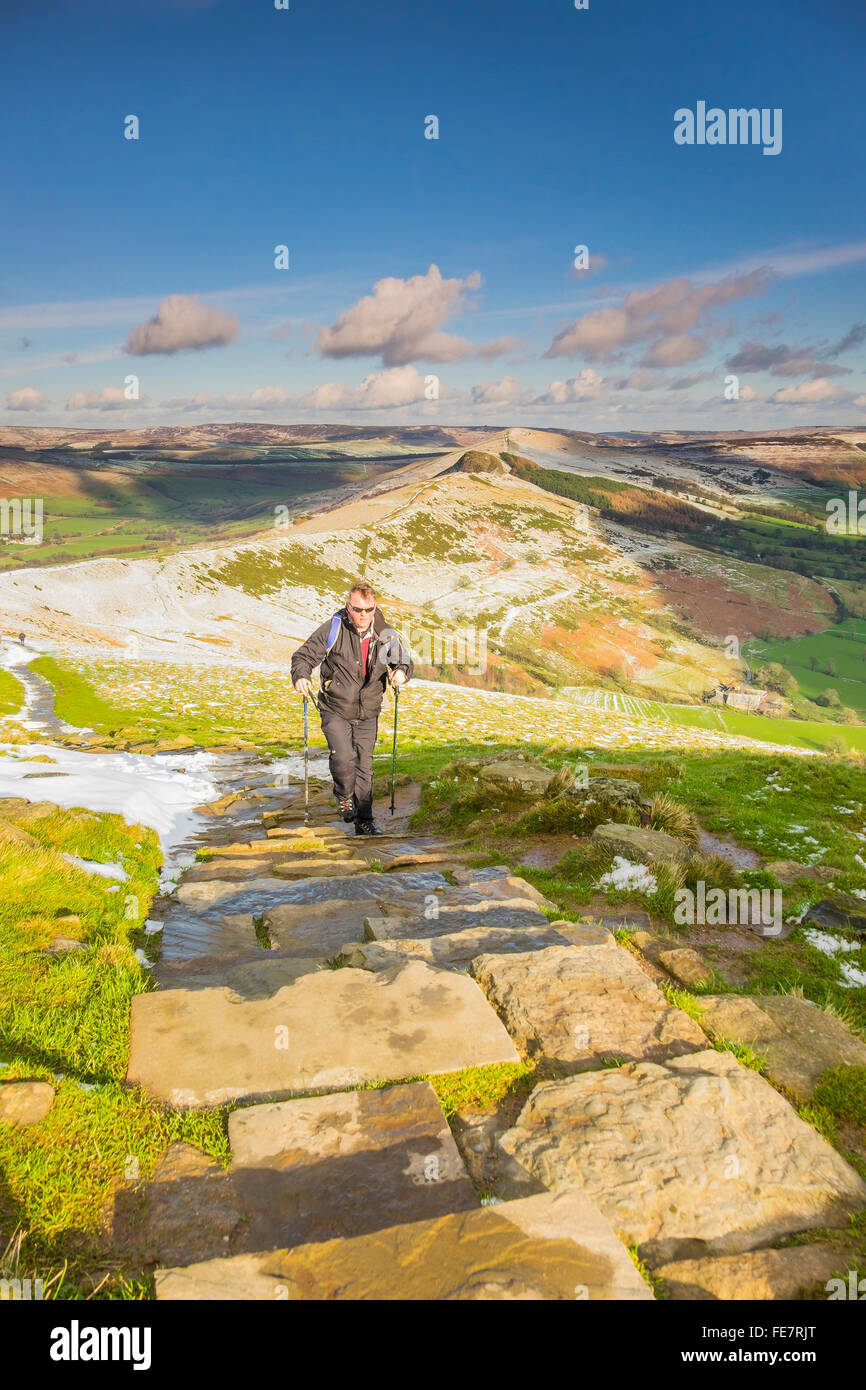 A walker climbs the steps to reach Mam Tor in Derbyshire Stock Photo ...