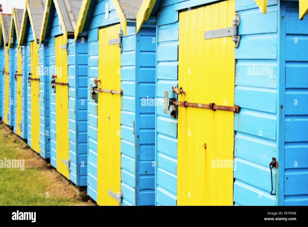 Traditional British beach huts at Uk seaside Brightly colored beach ...