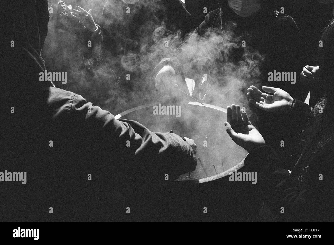 Group Of People Around Smoke Container Stock Photo - Alamy