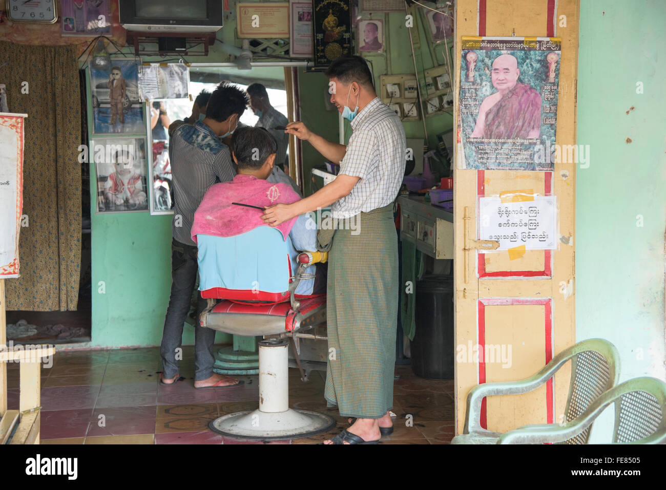 Barbershop with customer and barber working in Myeik, a city in ...
