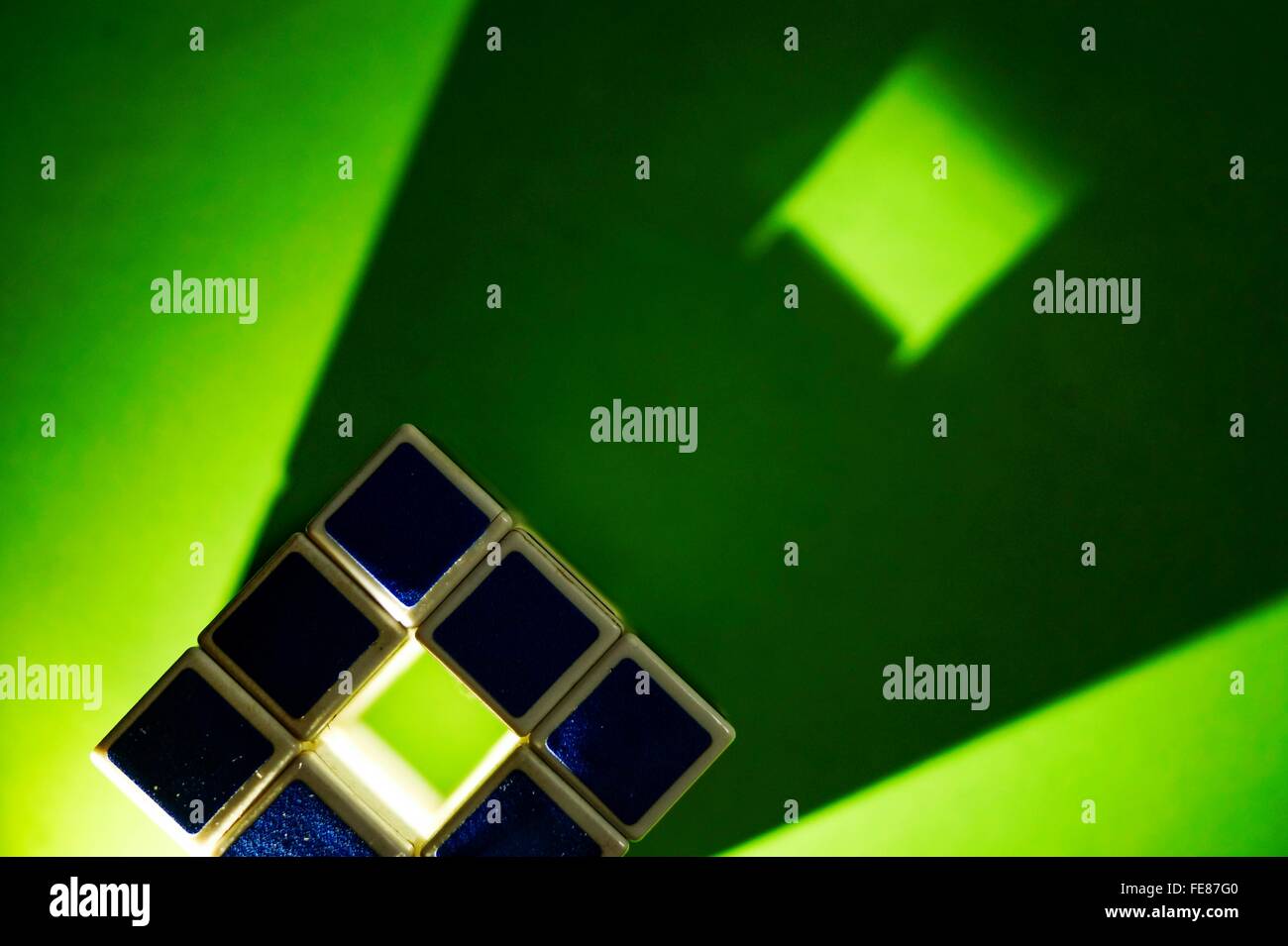 Cube Casting Shadow On Green Surface Stock Photo - Alamy