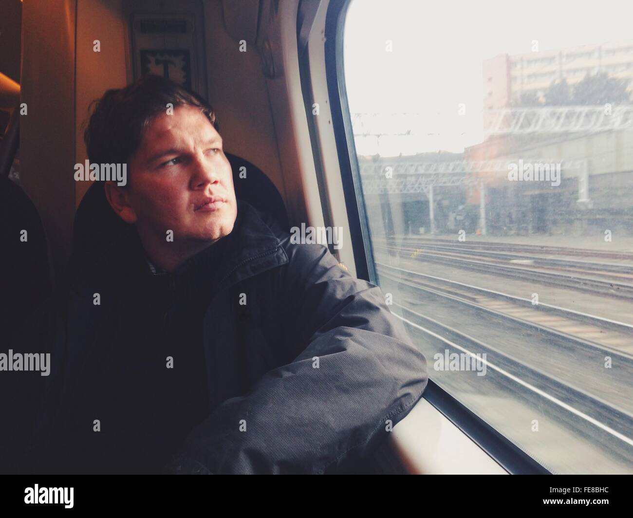 Man Looking Through Window While Travelling In Train Stock Photo - Alamy