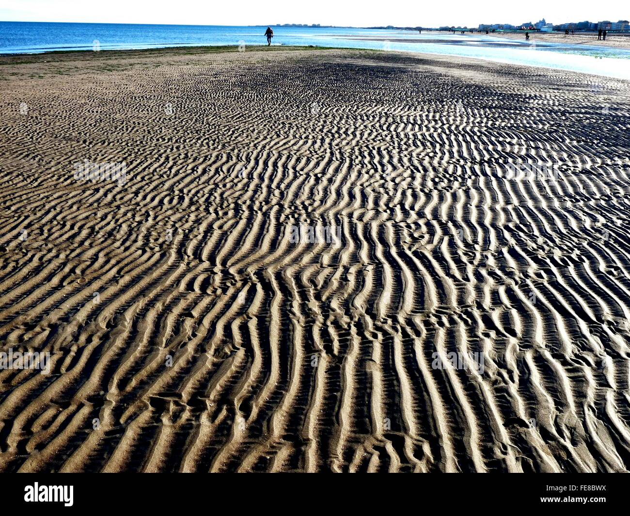 Wave Pattern On Wet Sand At Beach Stock Photo - Alamy