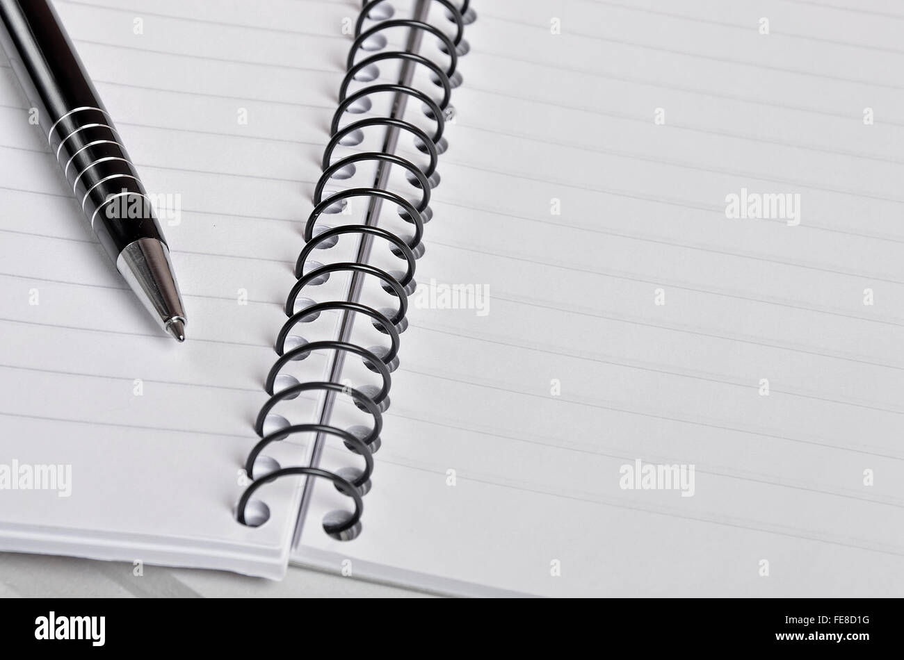 Pen and notebook on table Stock Photo - Alamy