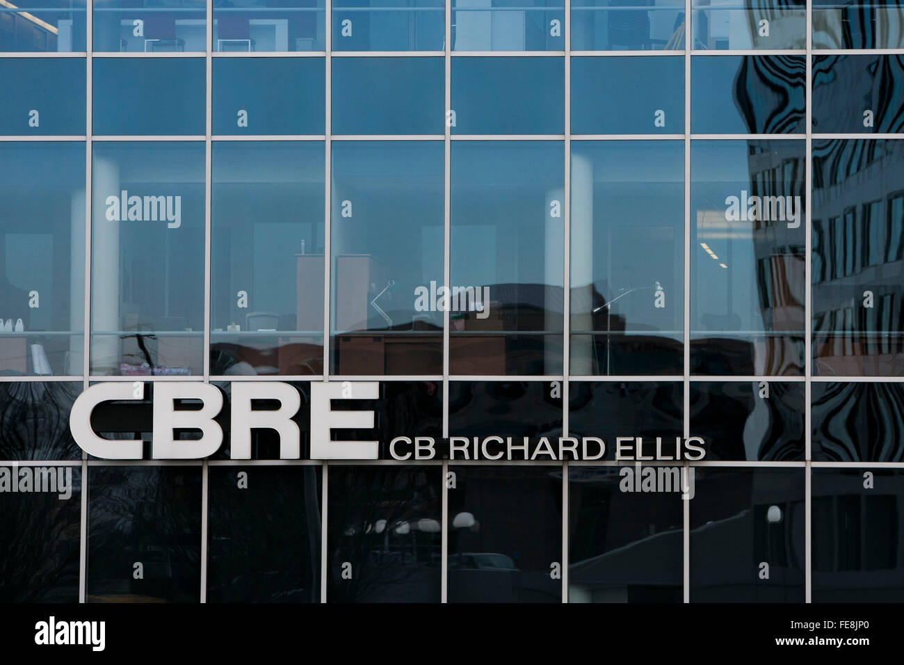 A logo sign outside of an office building occupied by CBRE Group, Inc ...