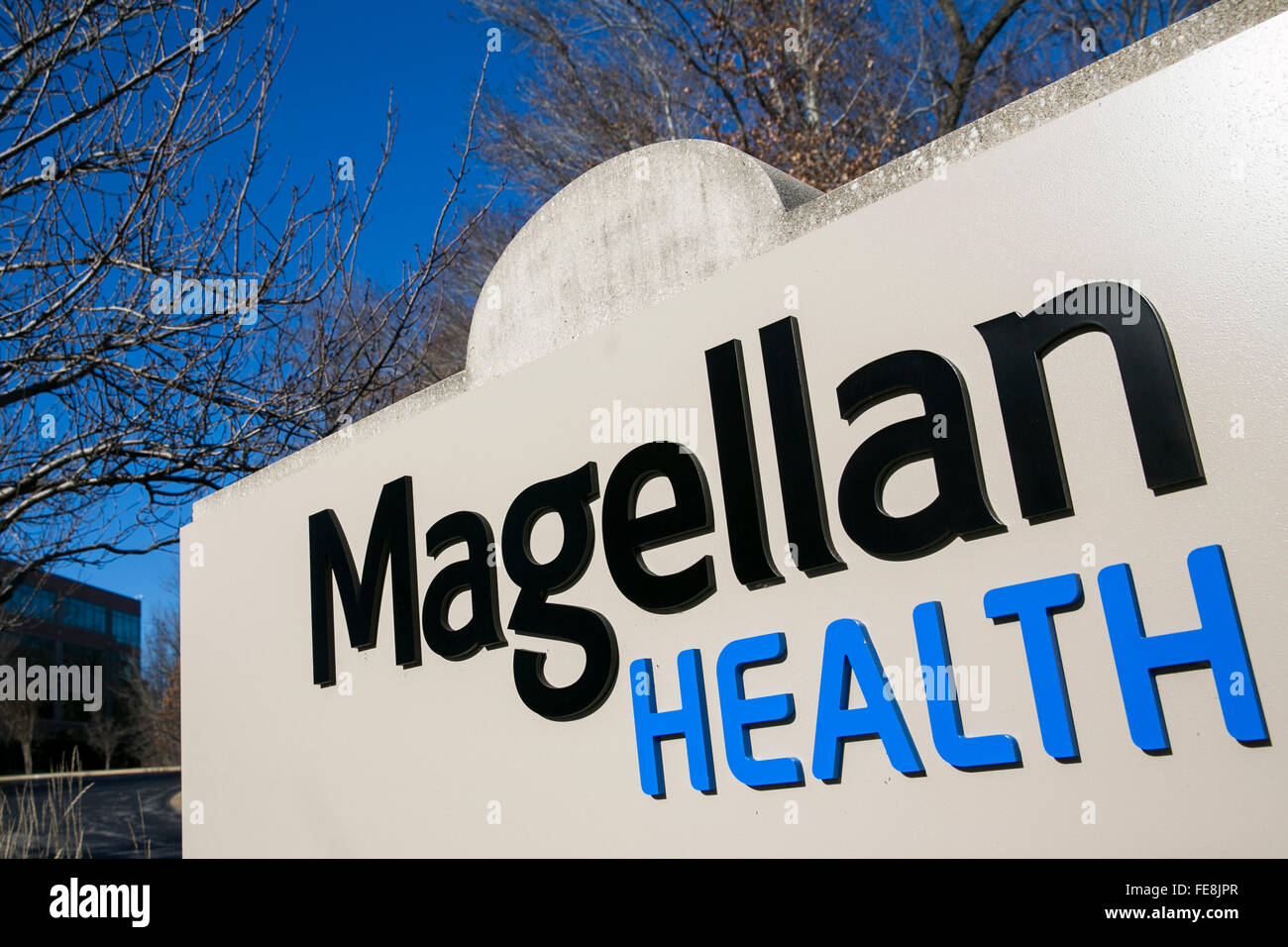 A logo sign outside of an office building occupied by Magellan Health ...