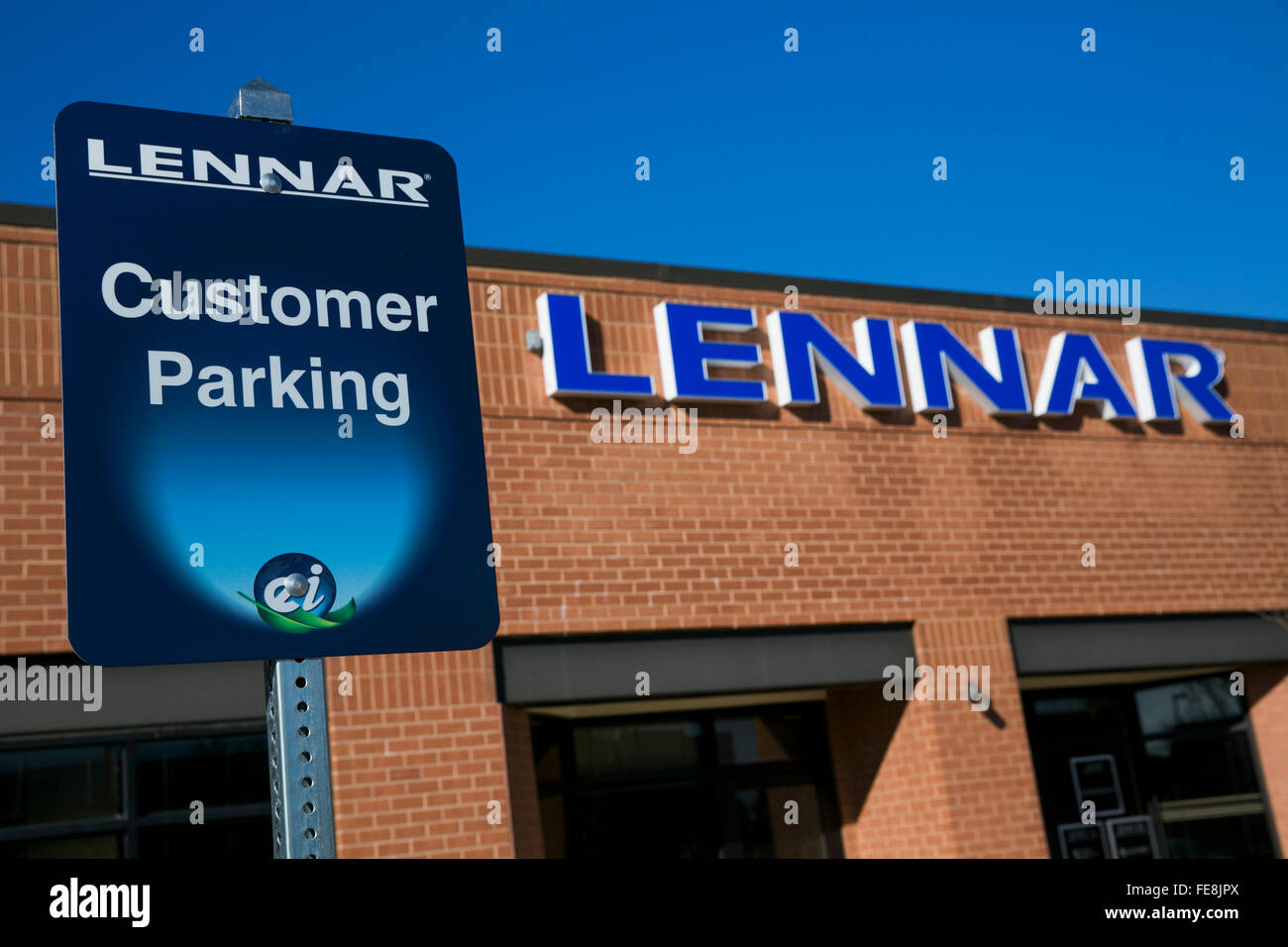 A logo sign outside of an office building occupied by the home builder ...