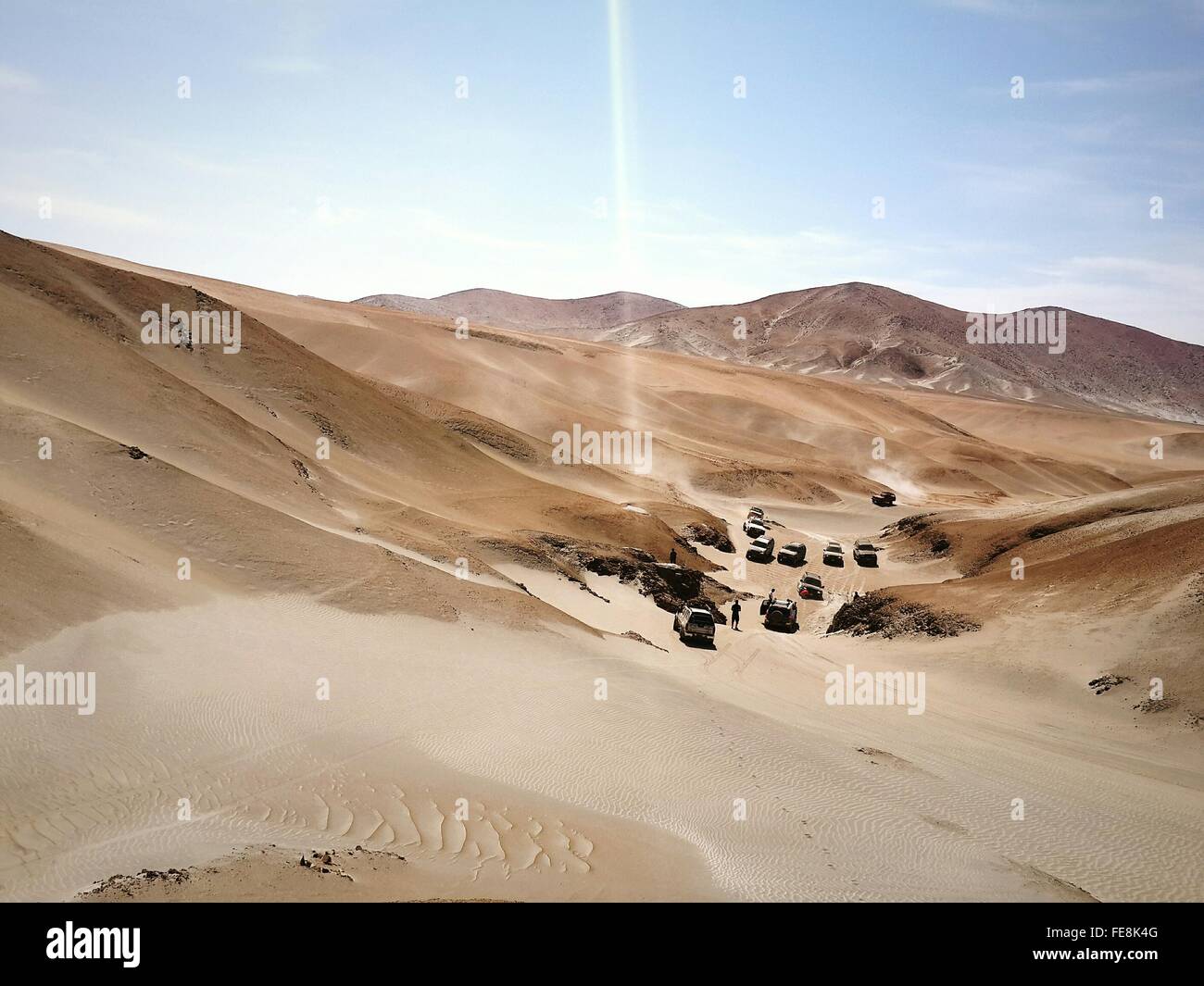 Vehicles On Road Along Desert Stock Photo - Alamy