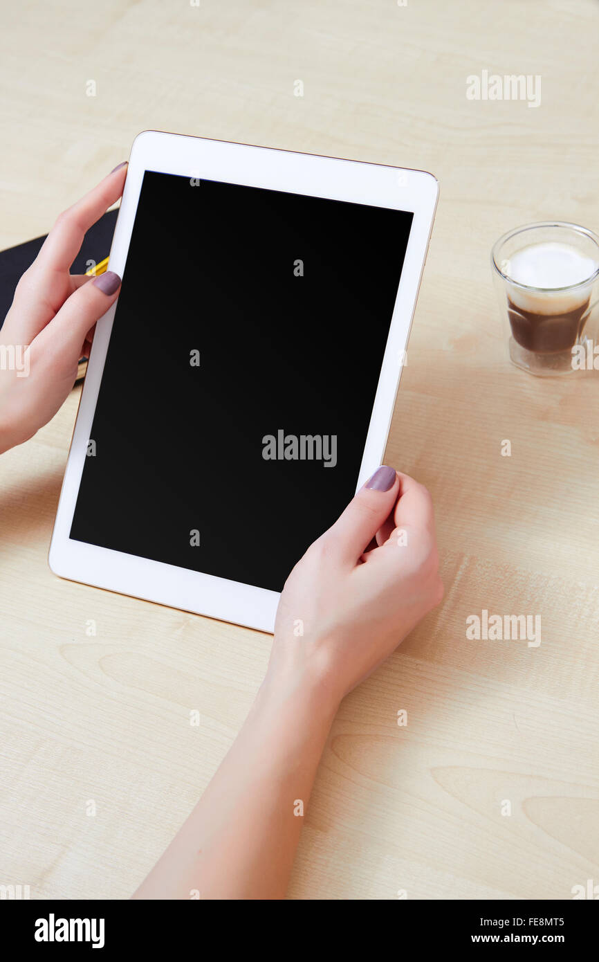 Hands holding a tablet at a desk, blank screen Stock Photo - Alamy