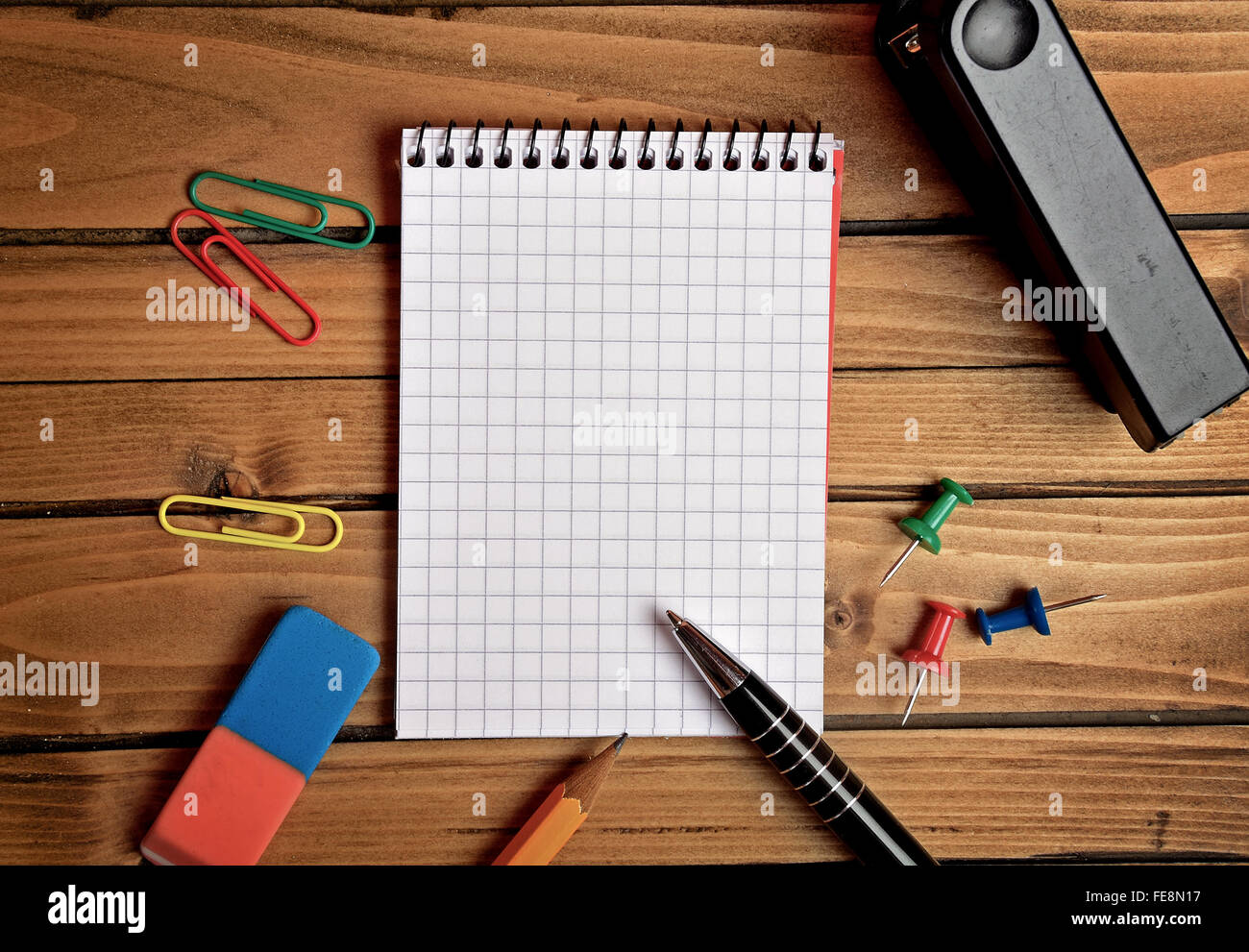 Assorted office supplies on wooden table Stock Photo - Alamy
