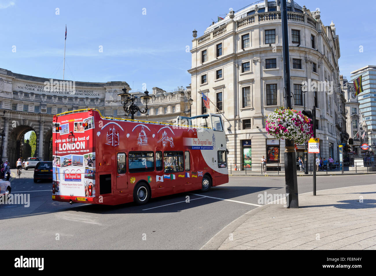 A modern red bus traveling near Trafalgar Square, London, United ...