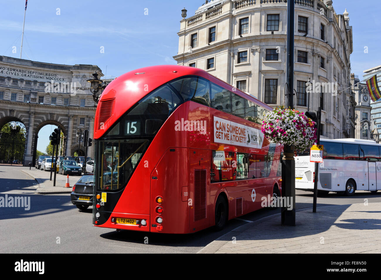 A modern red bus traveling near Trafalgar Square, London, United ...