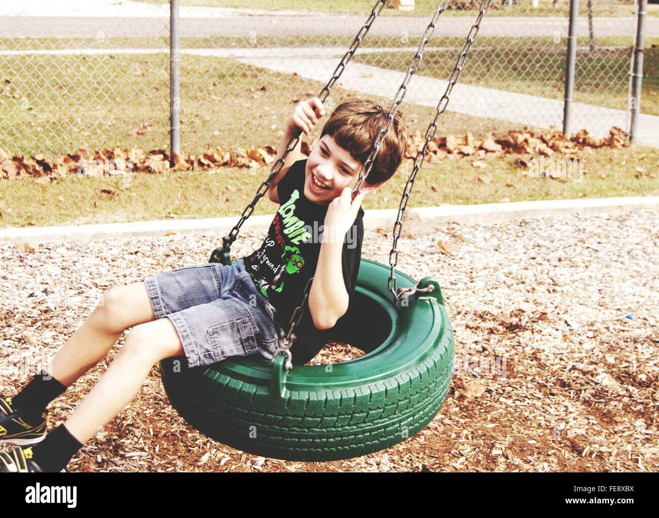Boy on swing hi-res stock photography and images - Alamy